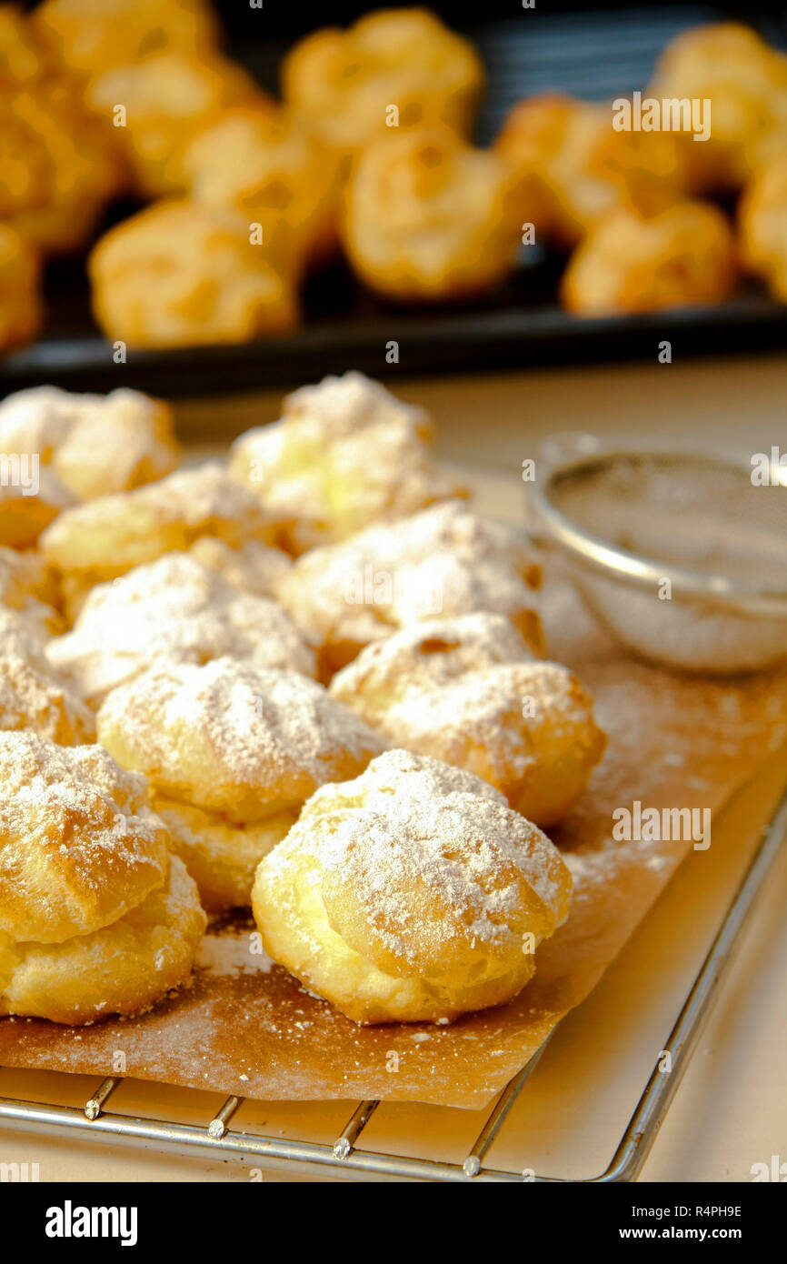 Wind cakes with mascarpone cheese filling in kitchen Stock Photo - Alamy
