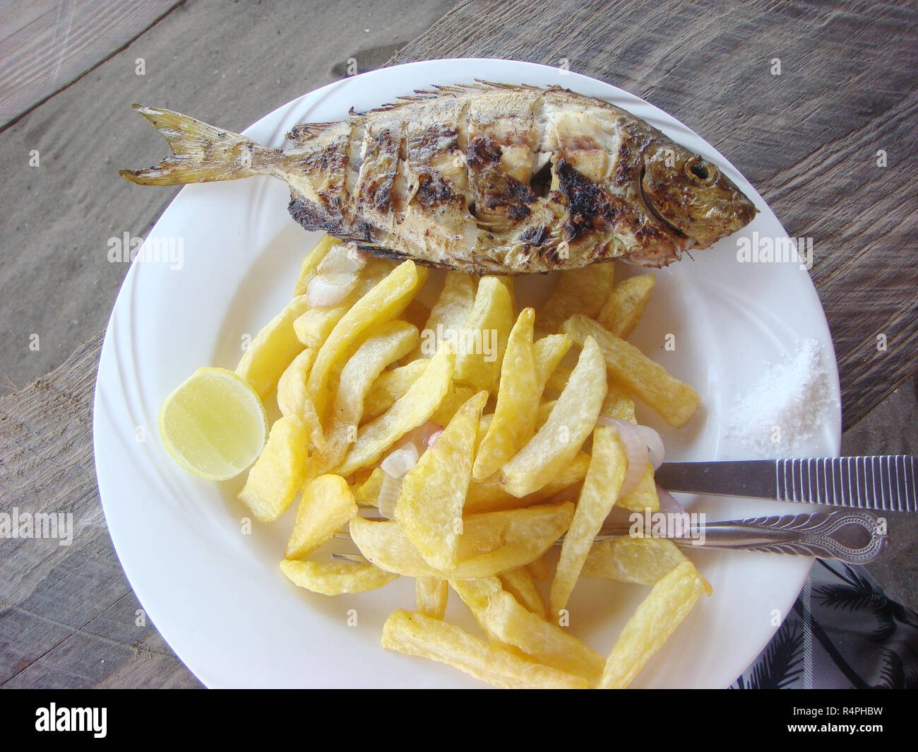 chipsy samaki chips with fried fish and salt on white dish Stock Photo ...