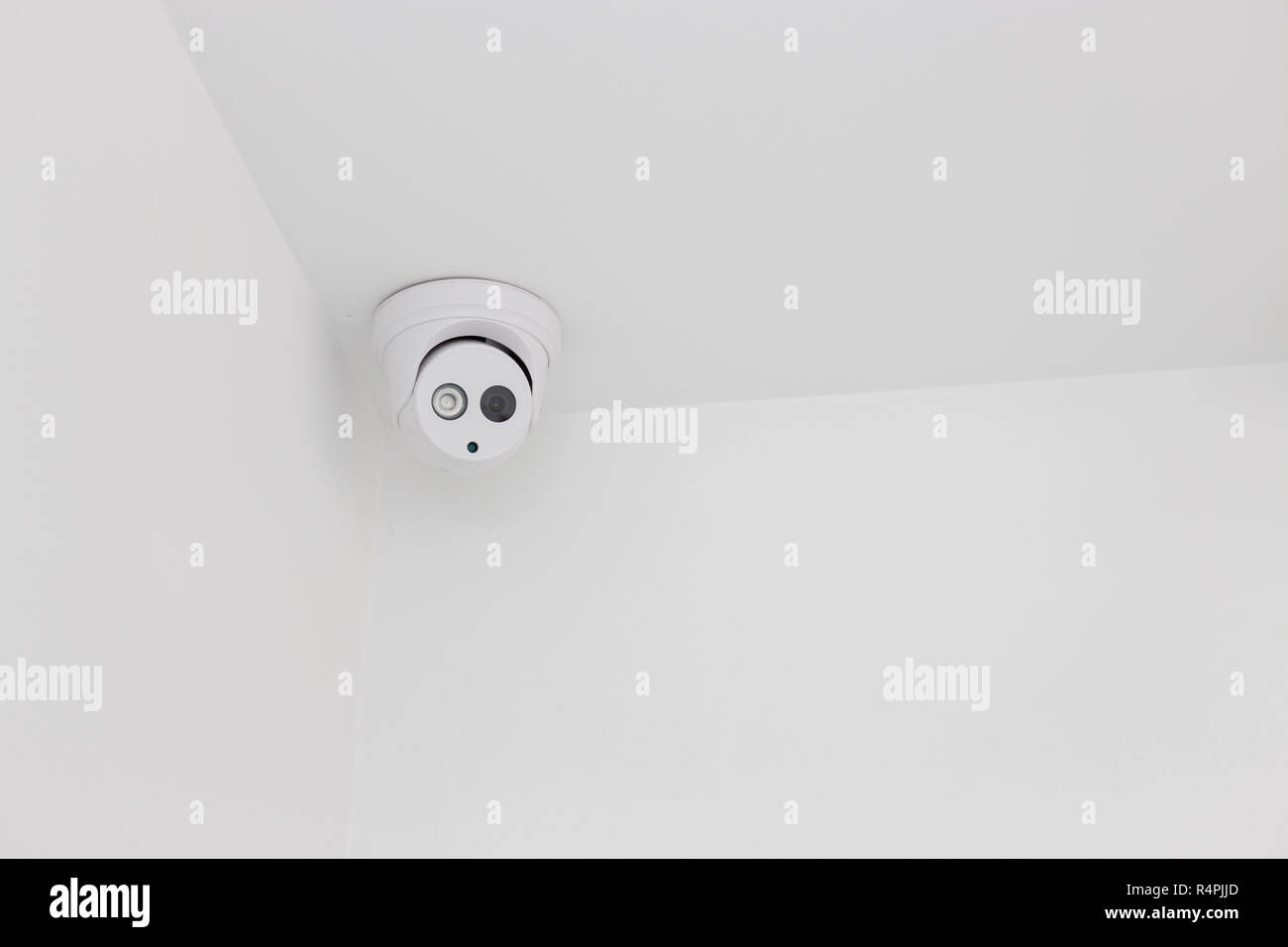 Ceiling Corner Of White Security Camera Stock Photo - Alamy
