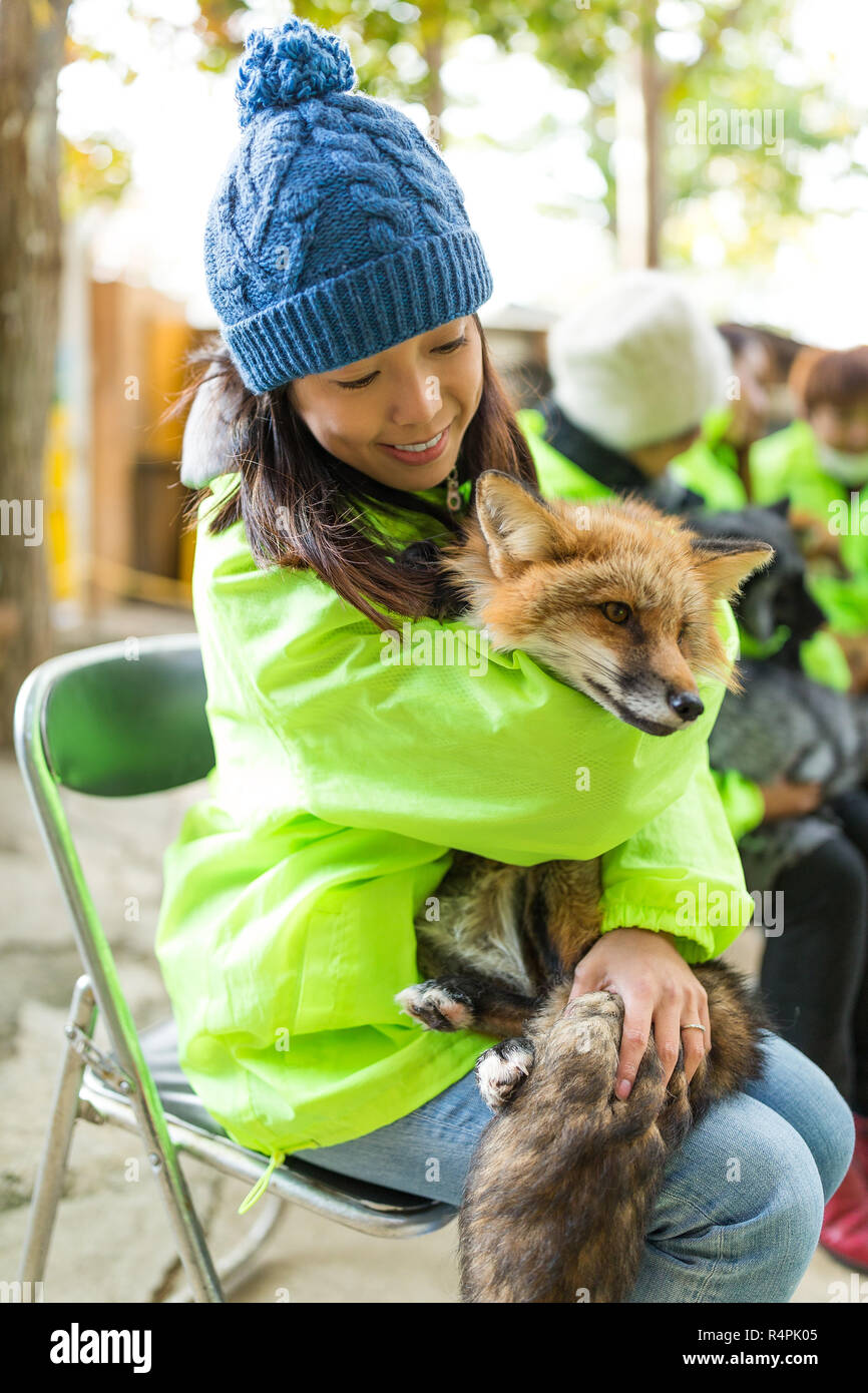 Woman hug with wild fox Stock Photo - Alamy