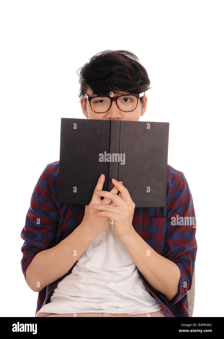 Asian man holding book for face Stock Photo - Alamy
