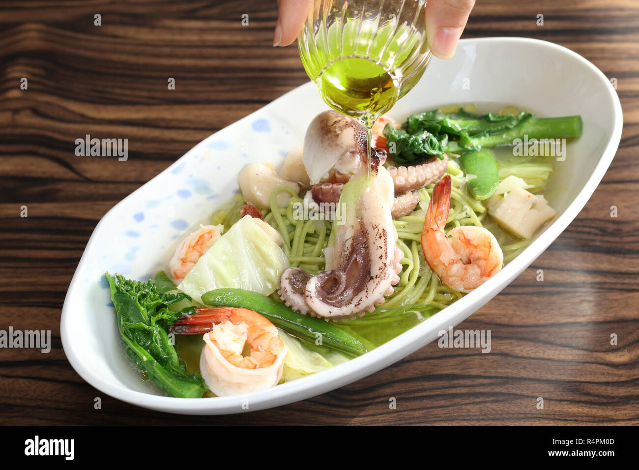 Sauteed octopus with shrimp, noodle, green bean, cabbage and oil Stock ...