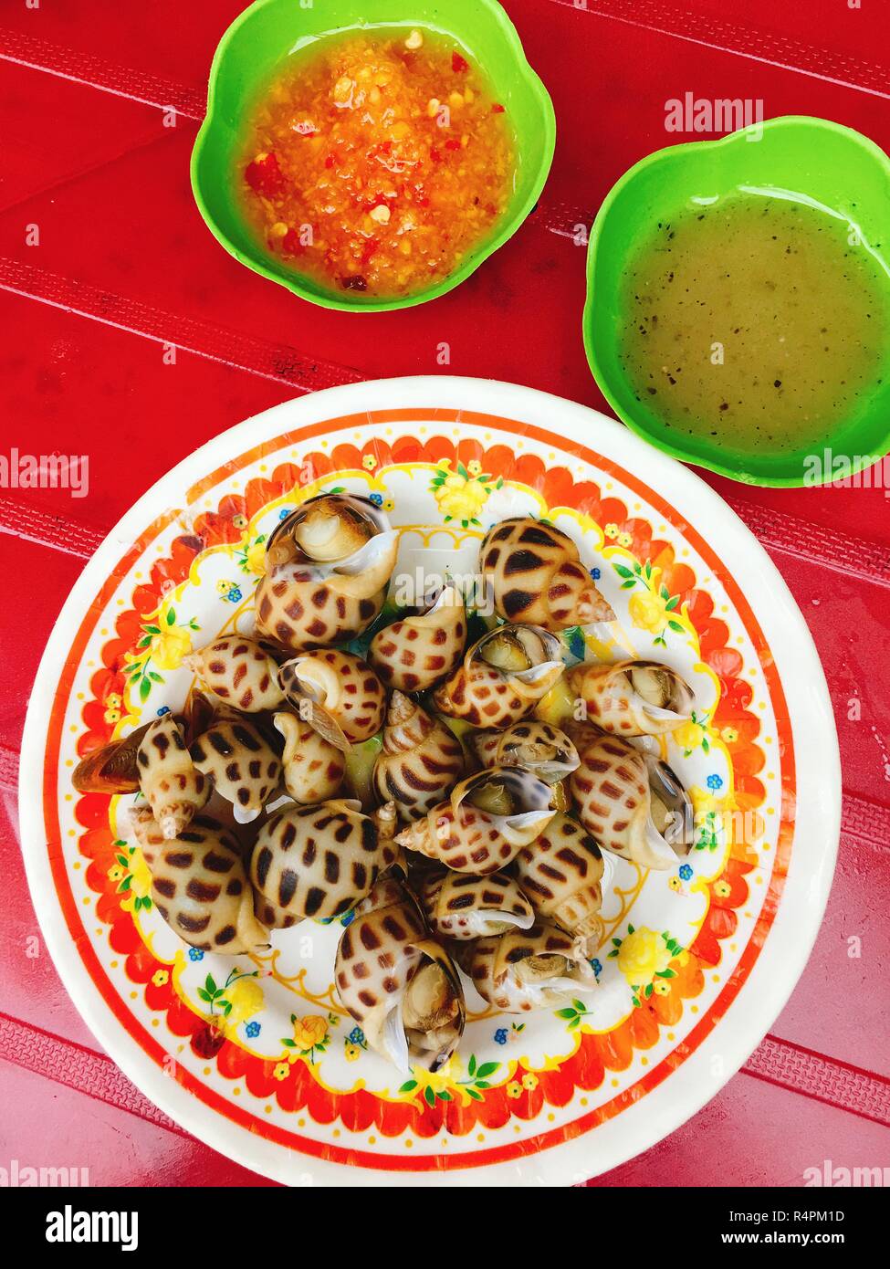 Steamed shells on dish for street food in Vietnam Stock Photo - Alamy