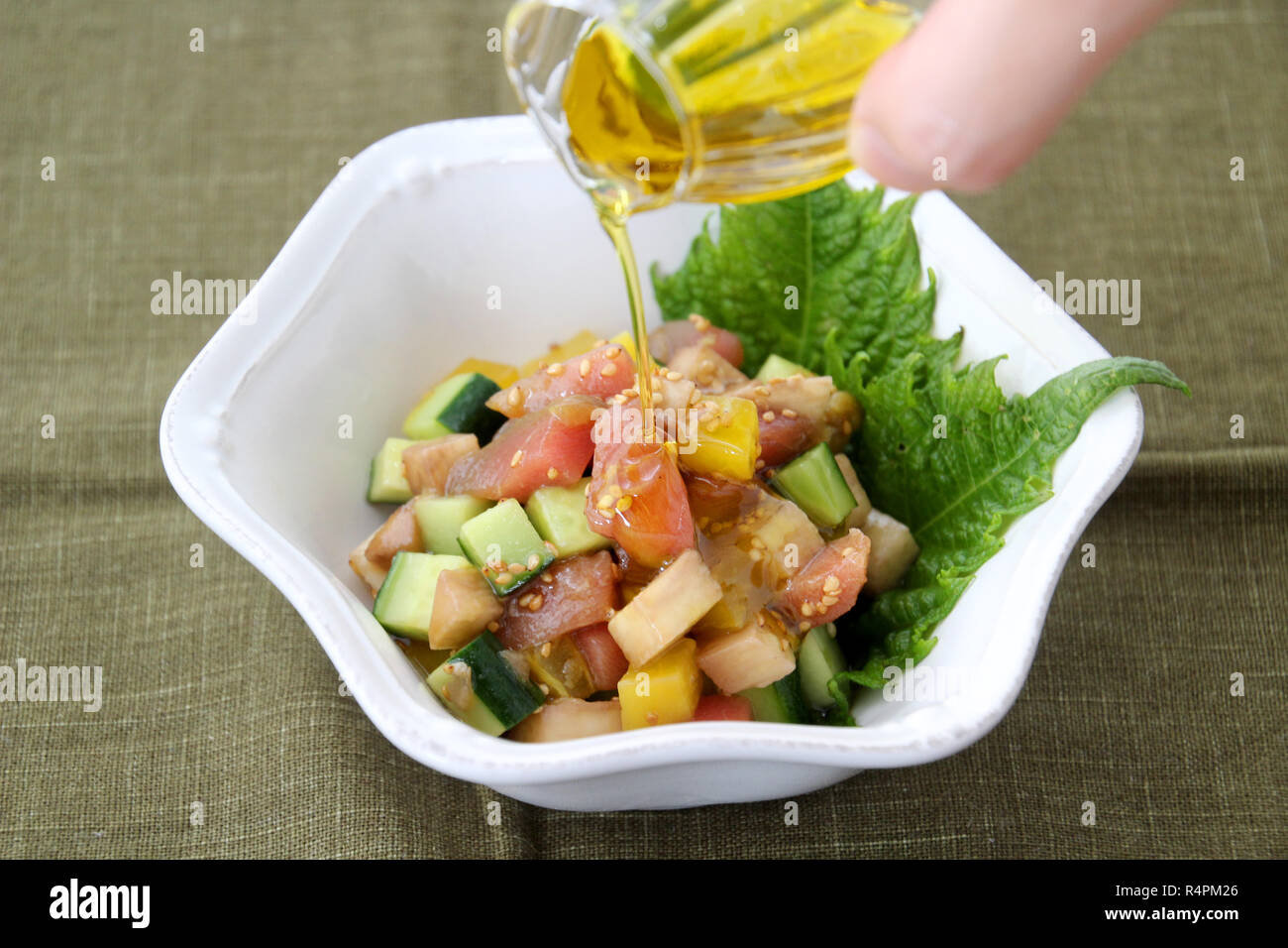 Mixed salad of cubed cucumber and tuna in whitebowl Stock Photo - Alamy