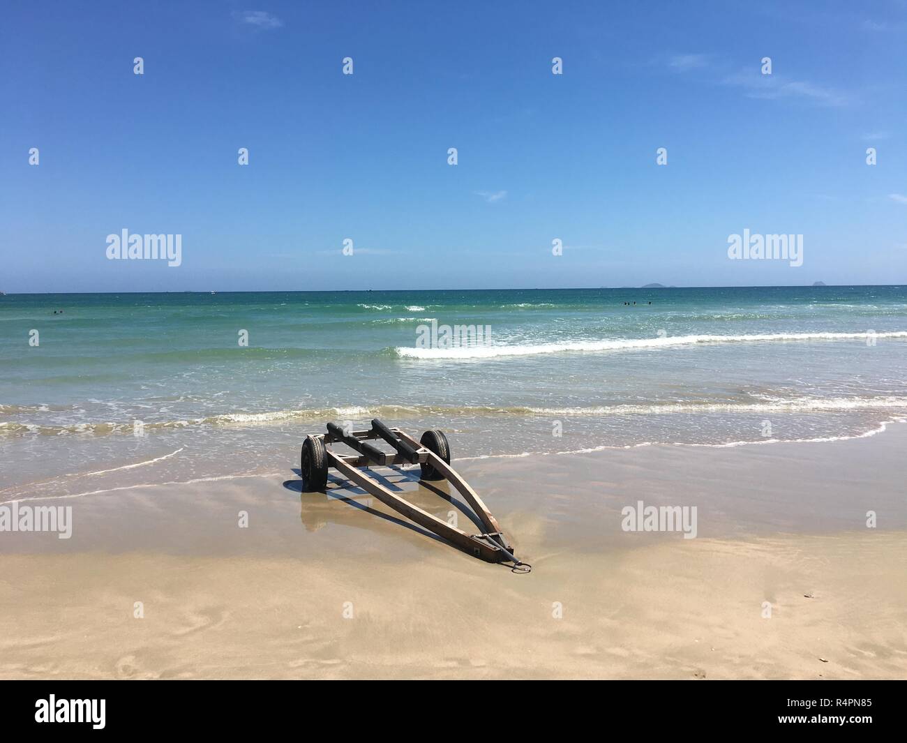The wheelbarrow on the beach with sea wave foam Stock Photo - Alamy