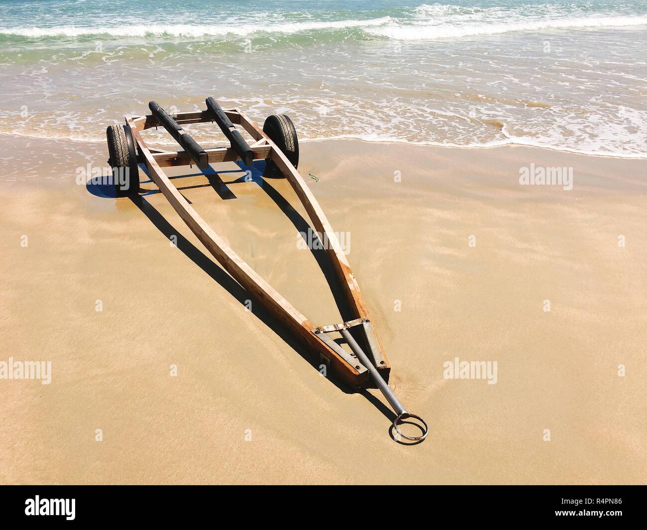 The wheelbarrow on the beach with sea wave foam Stock Photo - Alamy