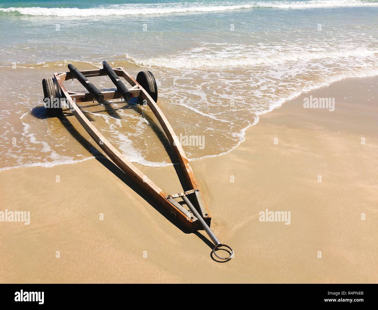 The wheelbarrow on the beach with sea wave foam Stock Photo - Alamy