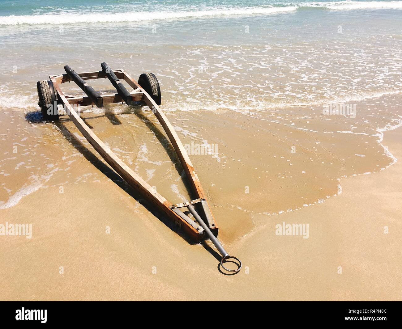 The wheelbarrow on the beach with sea wave foam Stock Photo - Alamy