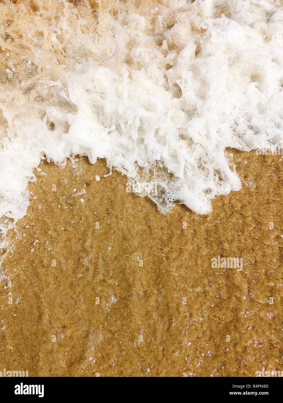 Sea waves reaching lapping to shore Stock Photo - Alamy