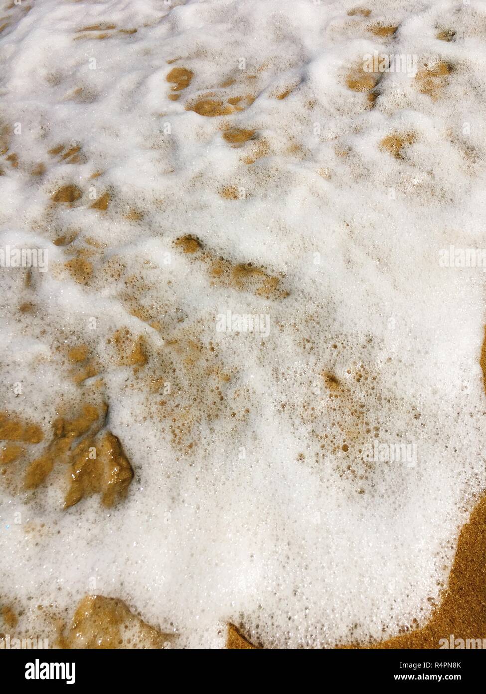 Sea waves reaching lapping to shore Stock Photo - Alamy