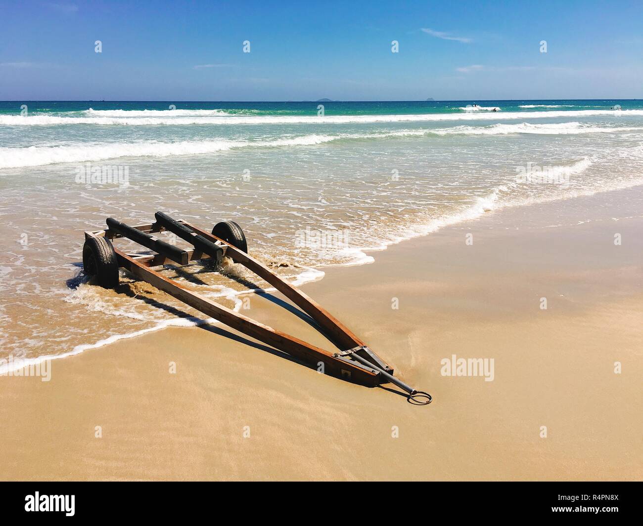 The wheelbarrow on the beach with sea wave foam Stock Photo - Alamy