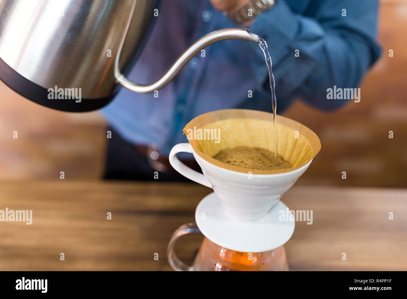 Barista pouring water on coffee with filter in coffee shop Stock Photo ...