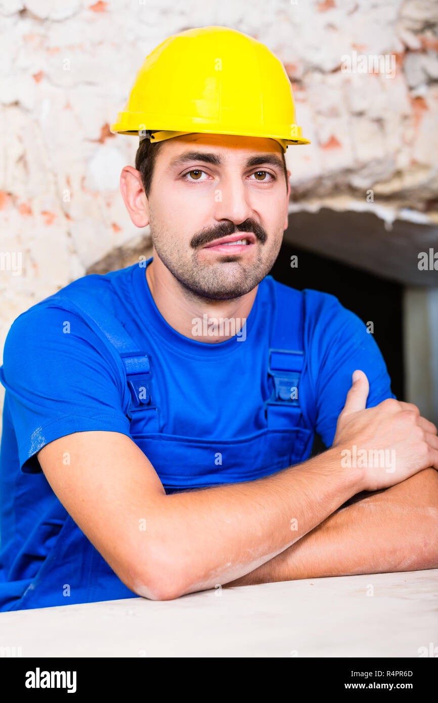 Unsatisfied construction worker on site grunting Stock Photo - Alamy