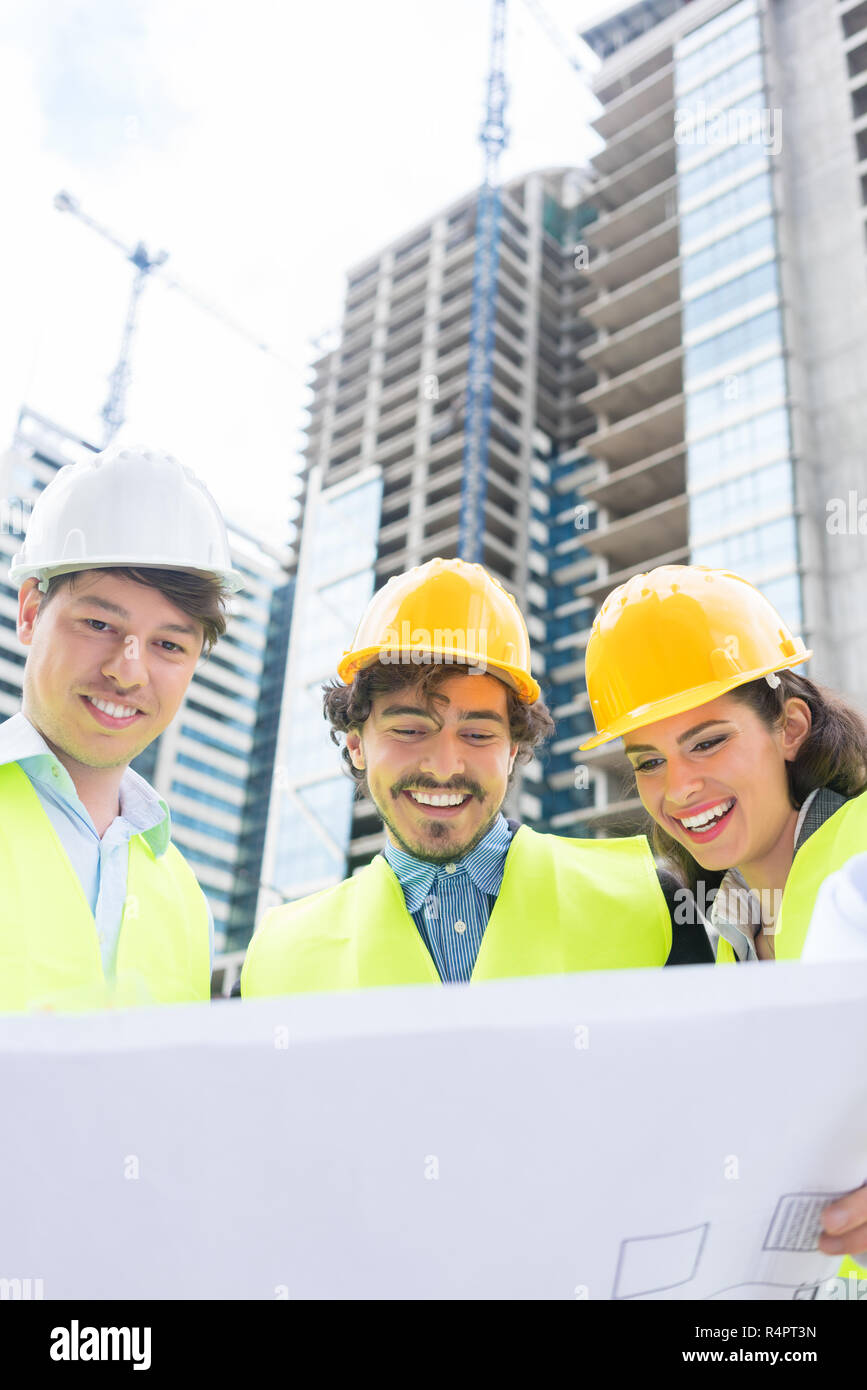 Architects with ground plot on construction site Stock Photo - Alamy