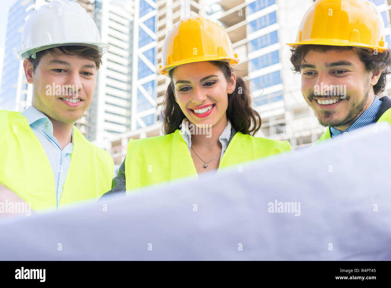 Architects with ground plot on construction site Stock Photo - Alamy