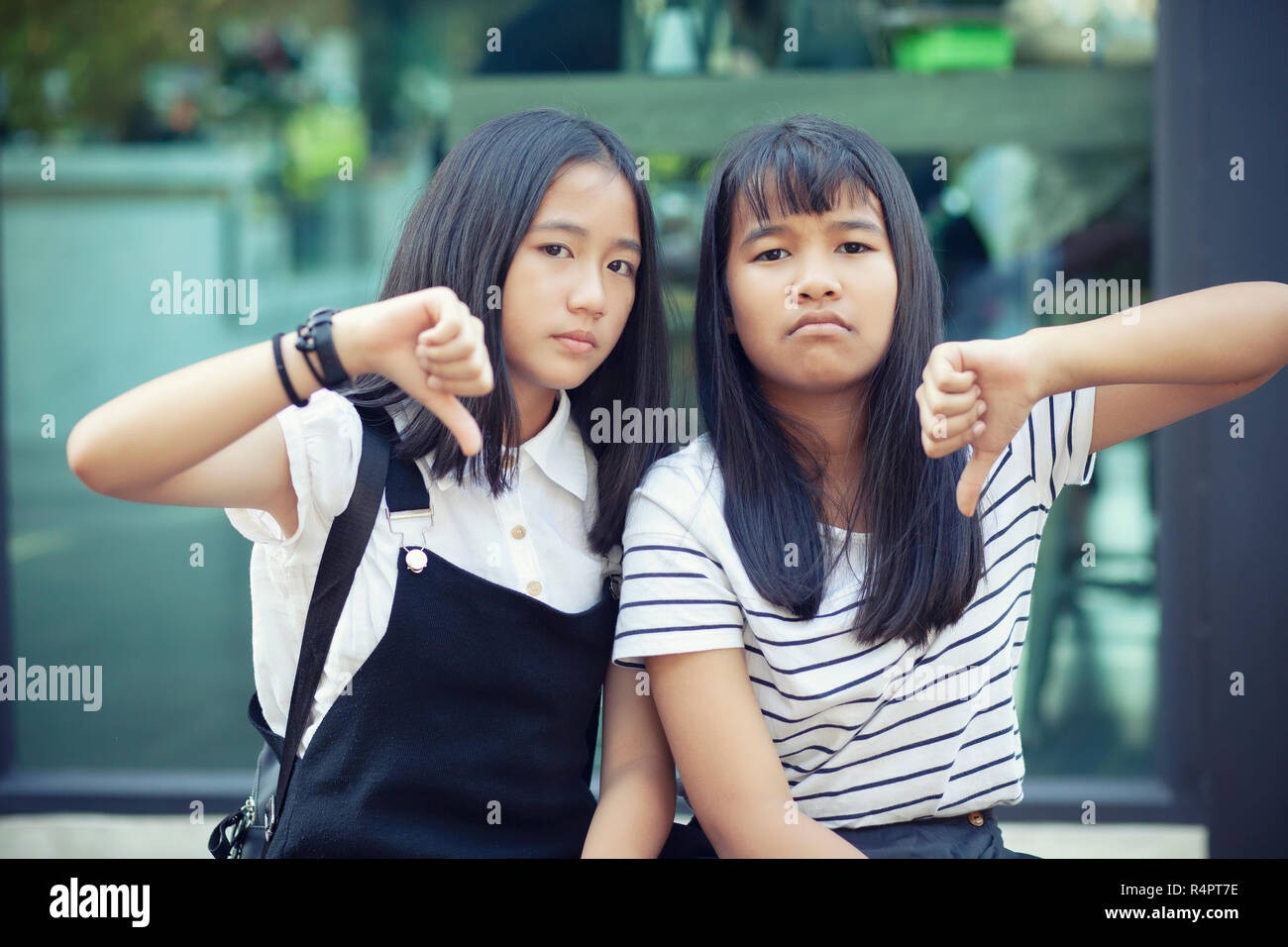 two asian teenager hand sign thumb no good with not satisfy face Stock ...