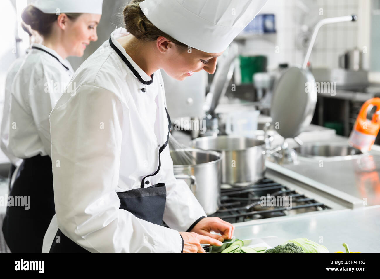 Female chefs at work in system catering Stock Photo - Alamy