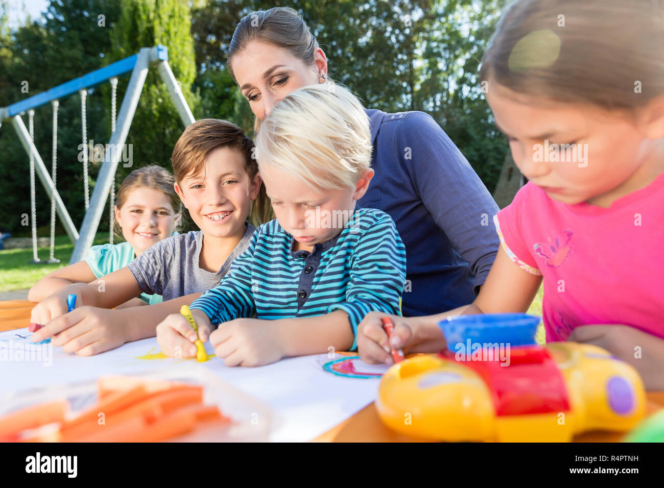 Mum painting pictures with their children and during lunch break Stock ...