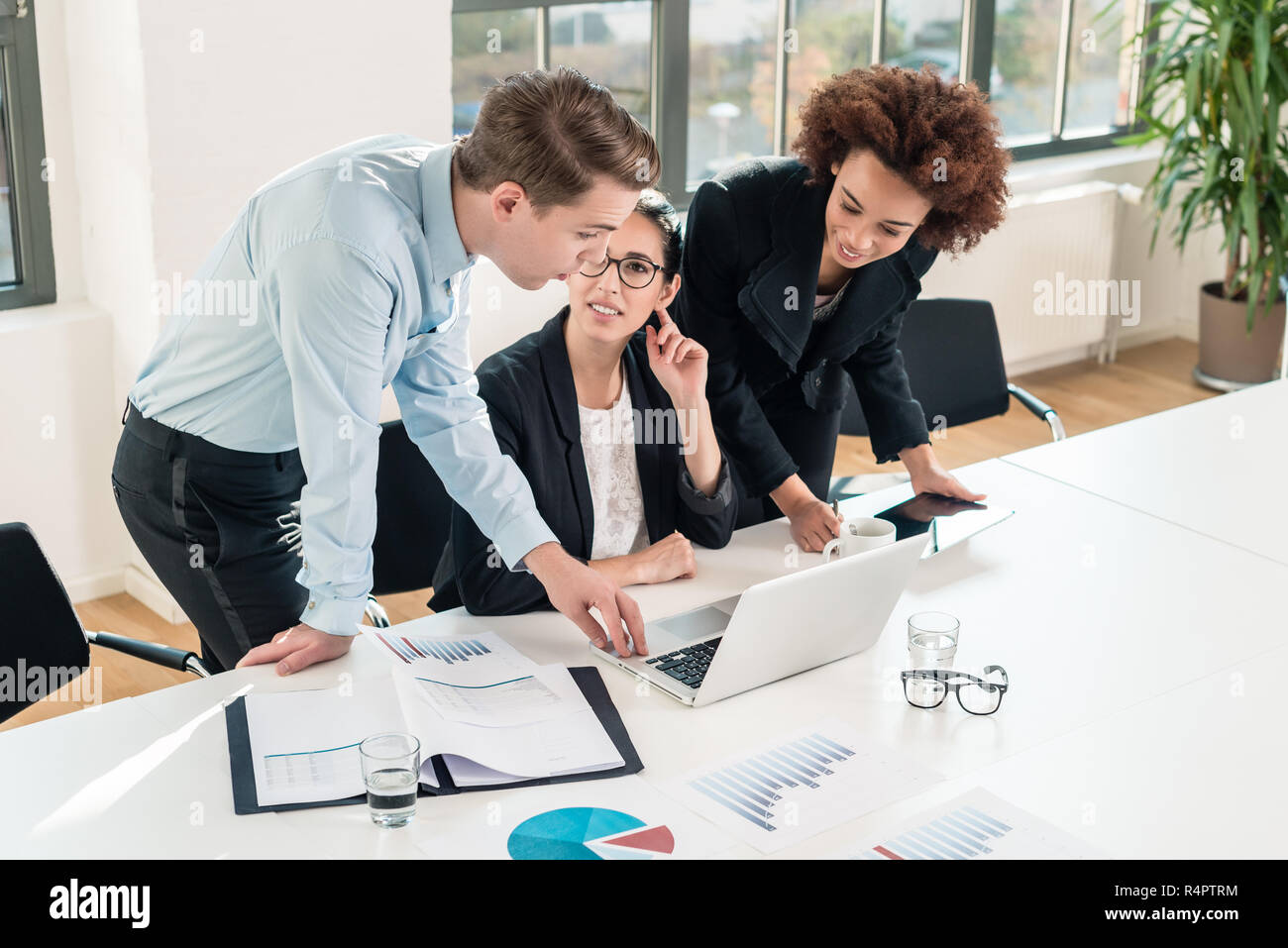 Three members of a young professional team working together Stock Photo ...