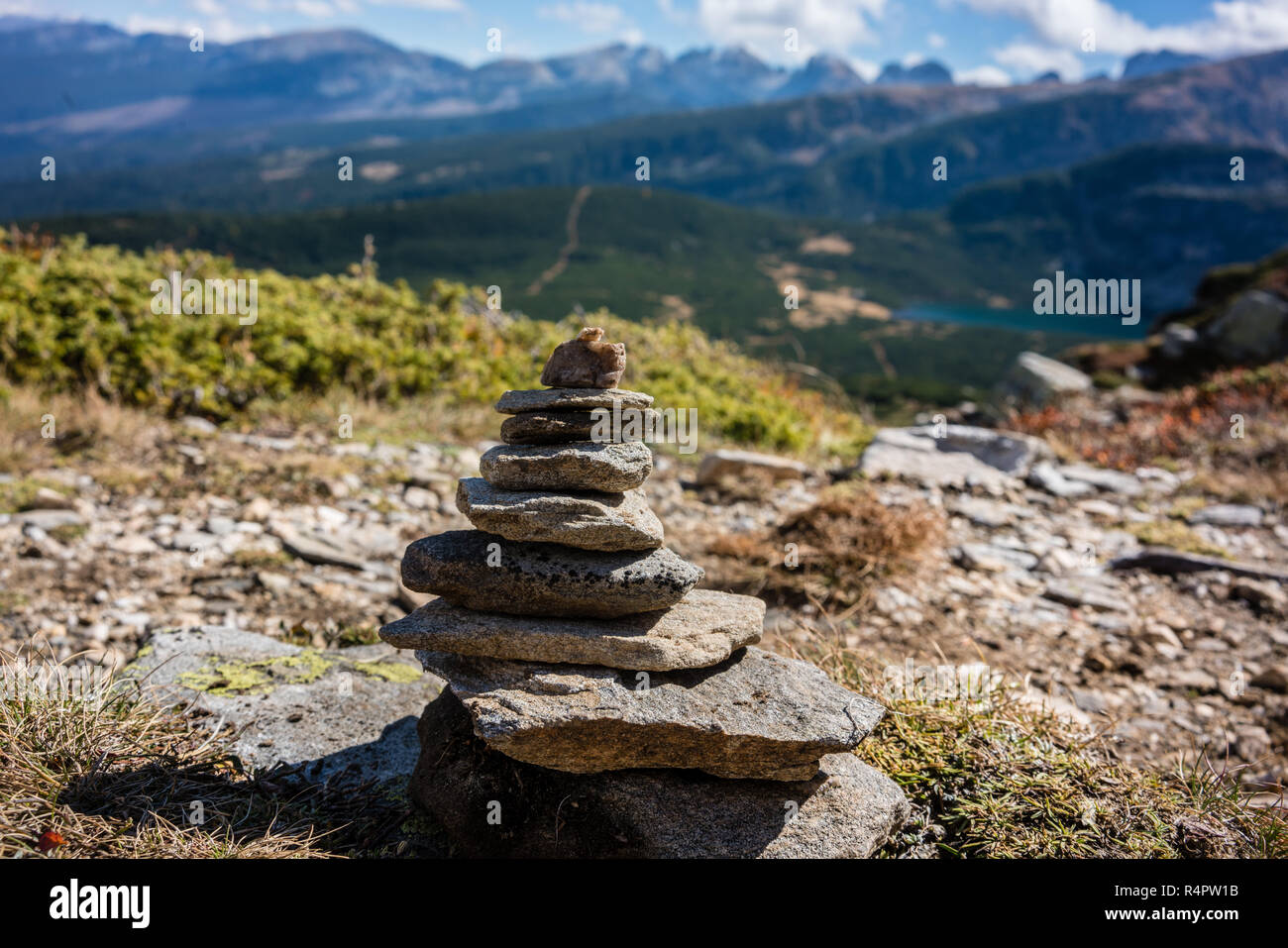Stone pyramid marking hiking path in the mountains Stock Photo - Alamy