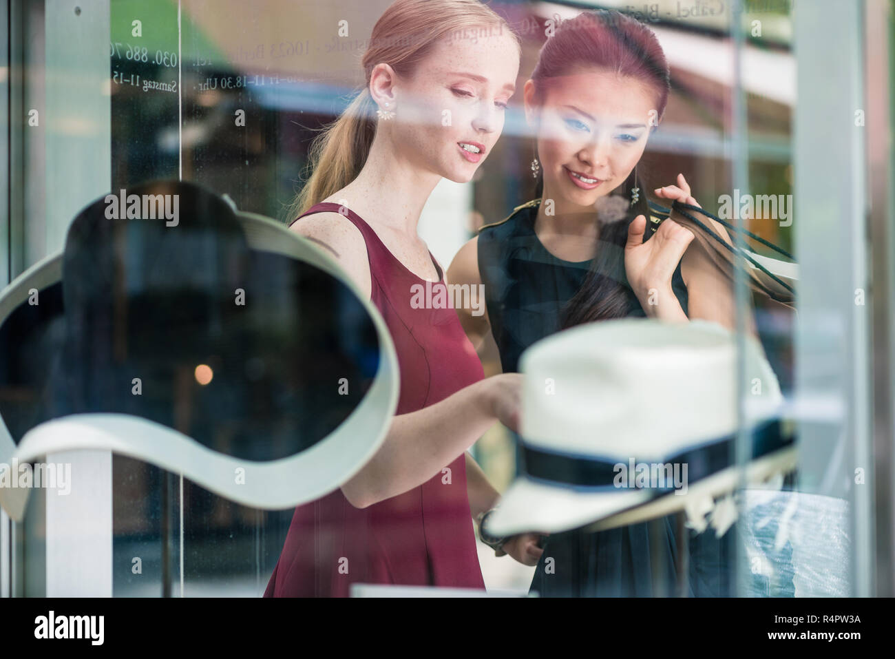 Two pretty young women window shopping Stock Photo - Alamy