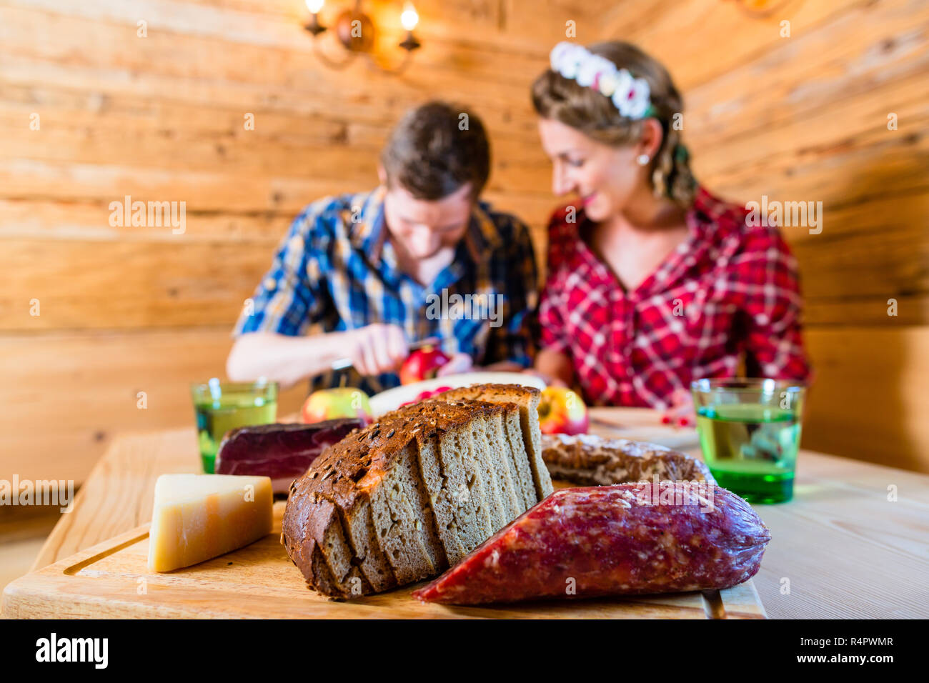 Couple having lunch in cabin on mountain Stock Photo - Alamy