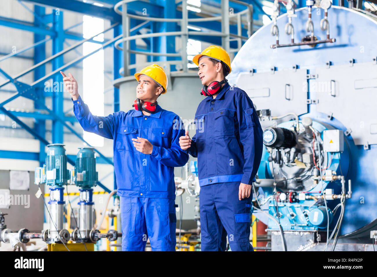 Worker in Asian manufacturing plant Stock Photo - Alamy
