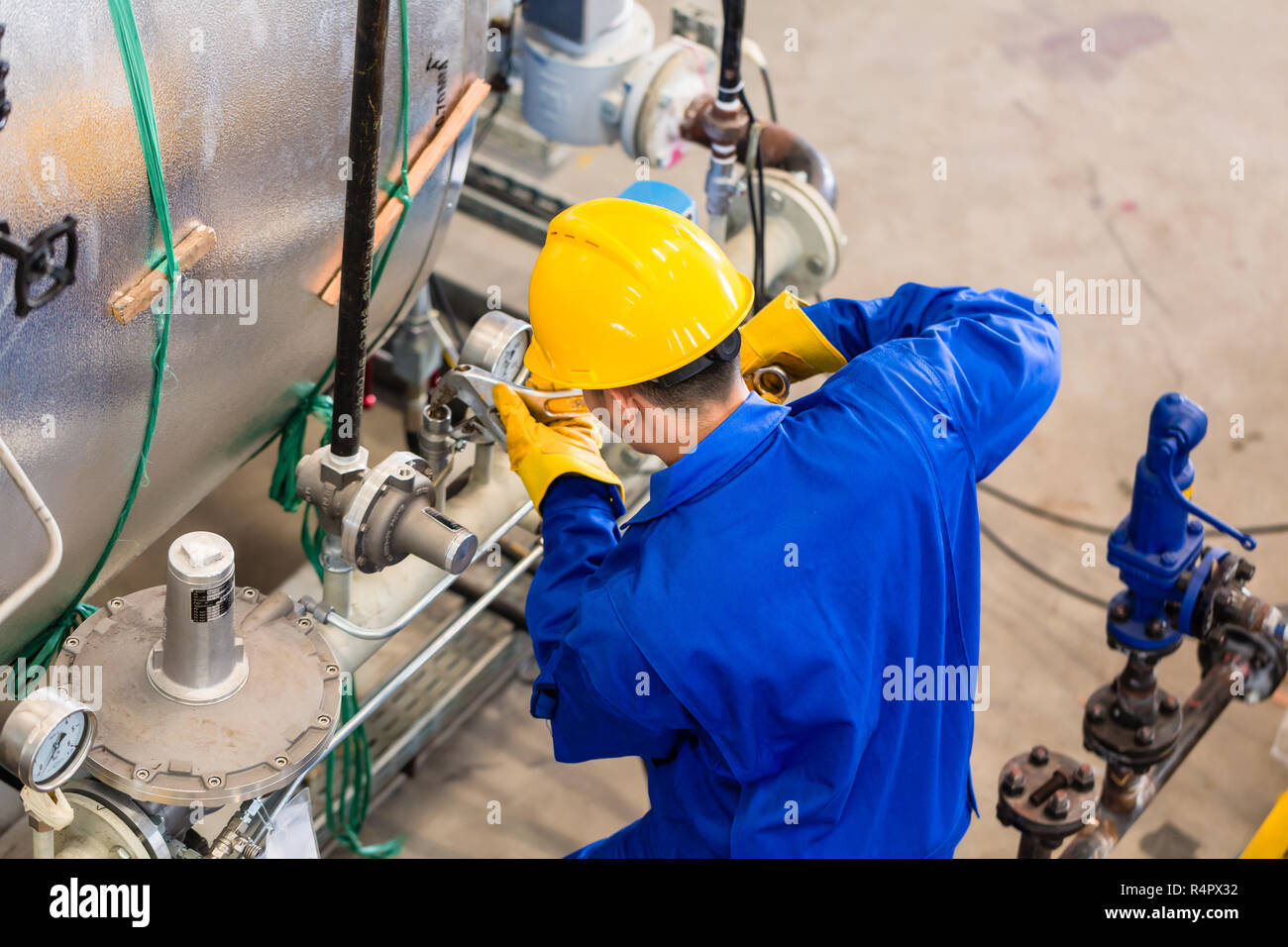 Industrial worker working at machine Stock Photo - Alamy