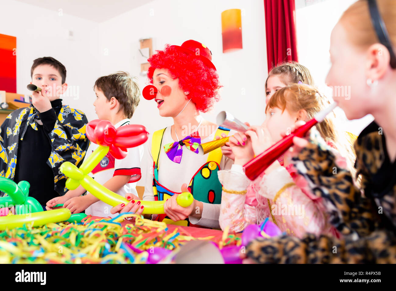Kids birthday party with clown and lot of noise Stock Photo - Alamy