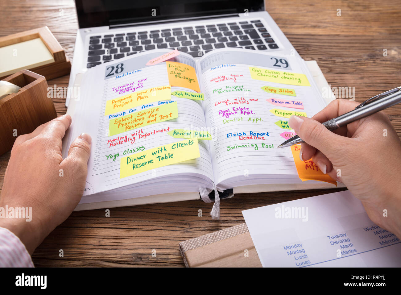 Businessperson Looking At List Of Schedule In Diary Stock Photo - Alamy