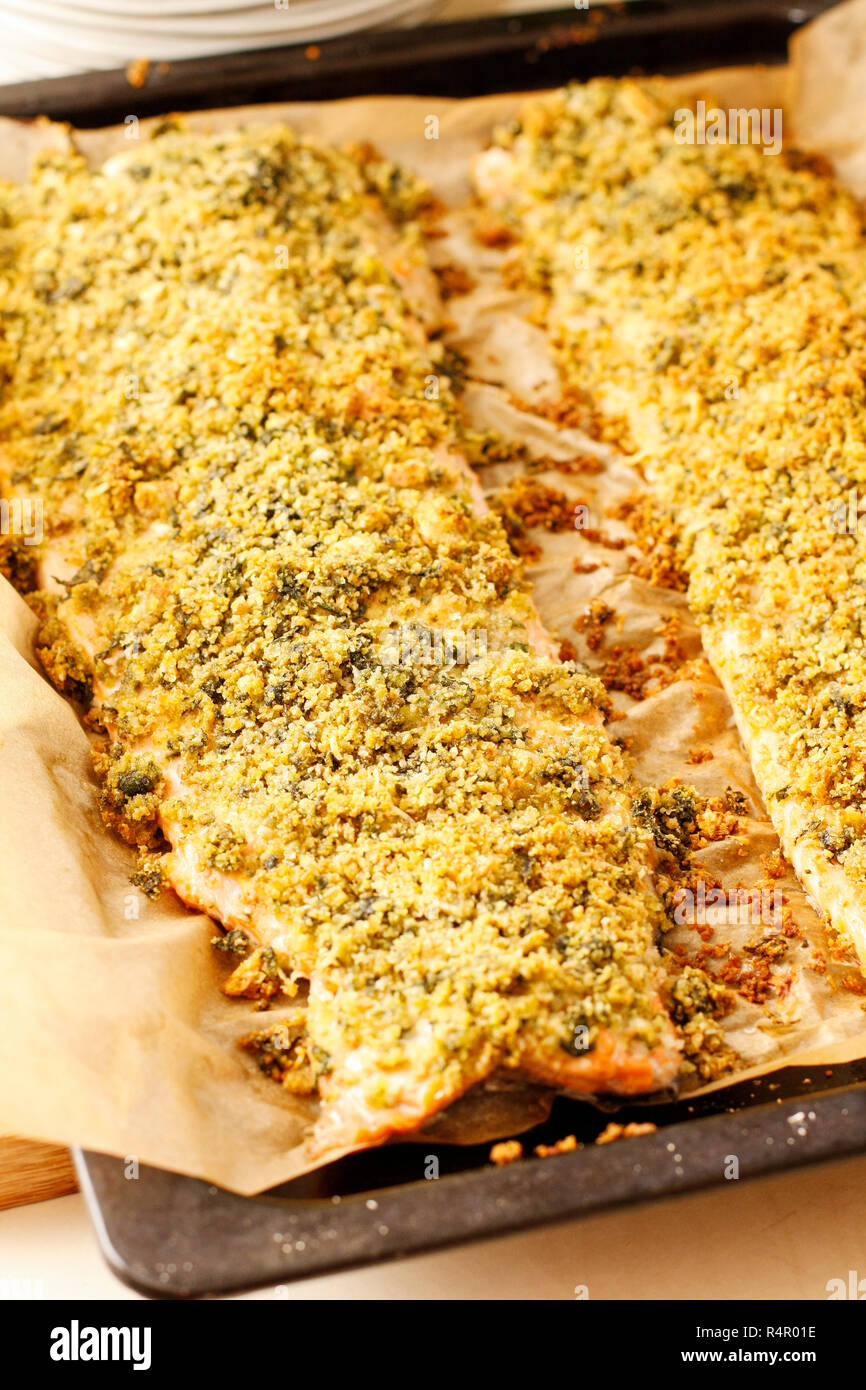 Baked salmon with basil and parmesan crust in black tray Stock Photo ...