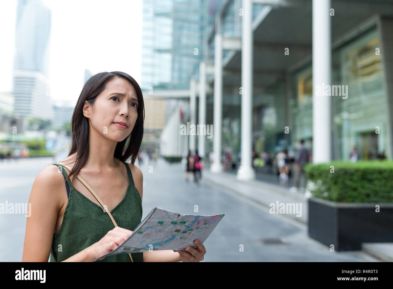 Woman finding the location on city map Stock Photo - Alamy
