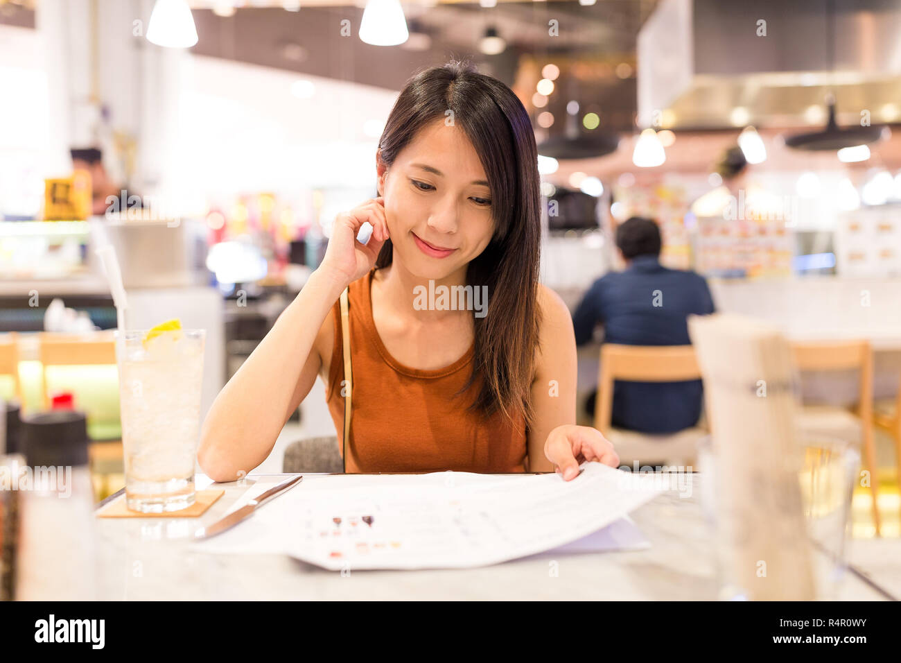Woman choosing on menu in restaurant Stock Photo - Alamy