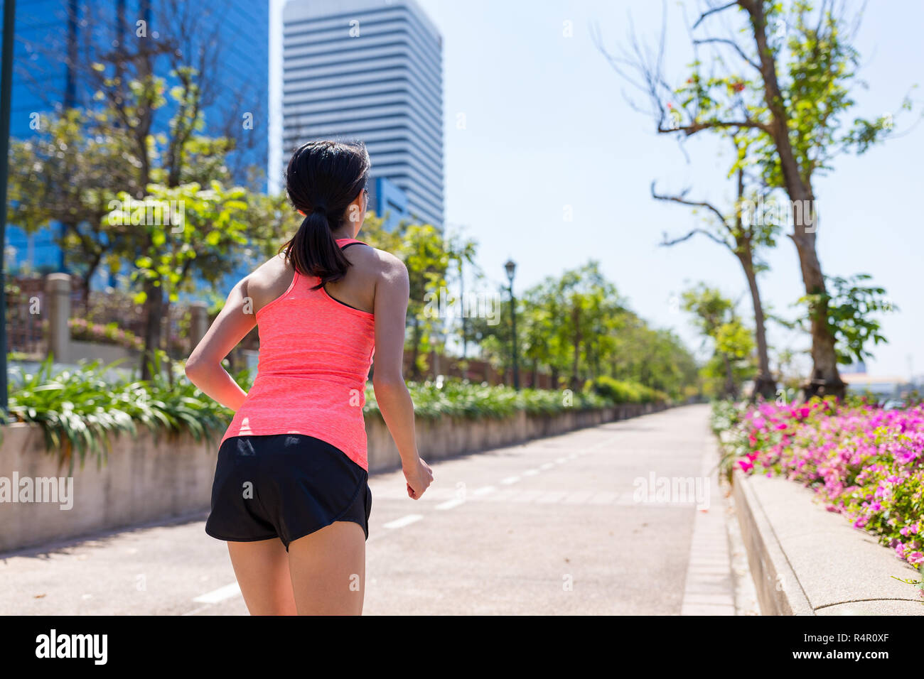 Back view of Sport woman practice running in park Stock Photo - Alamy