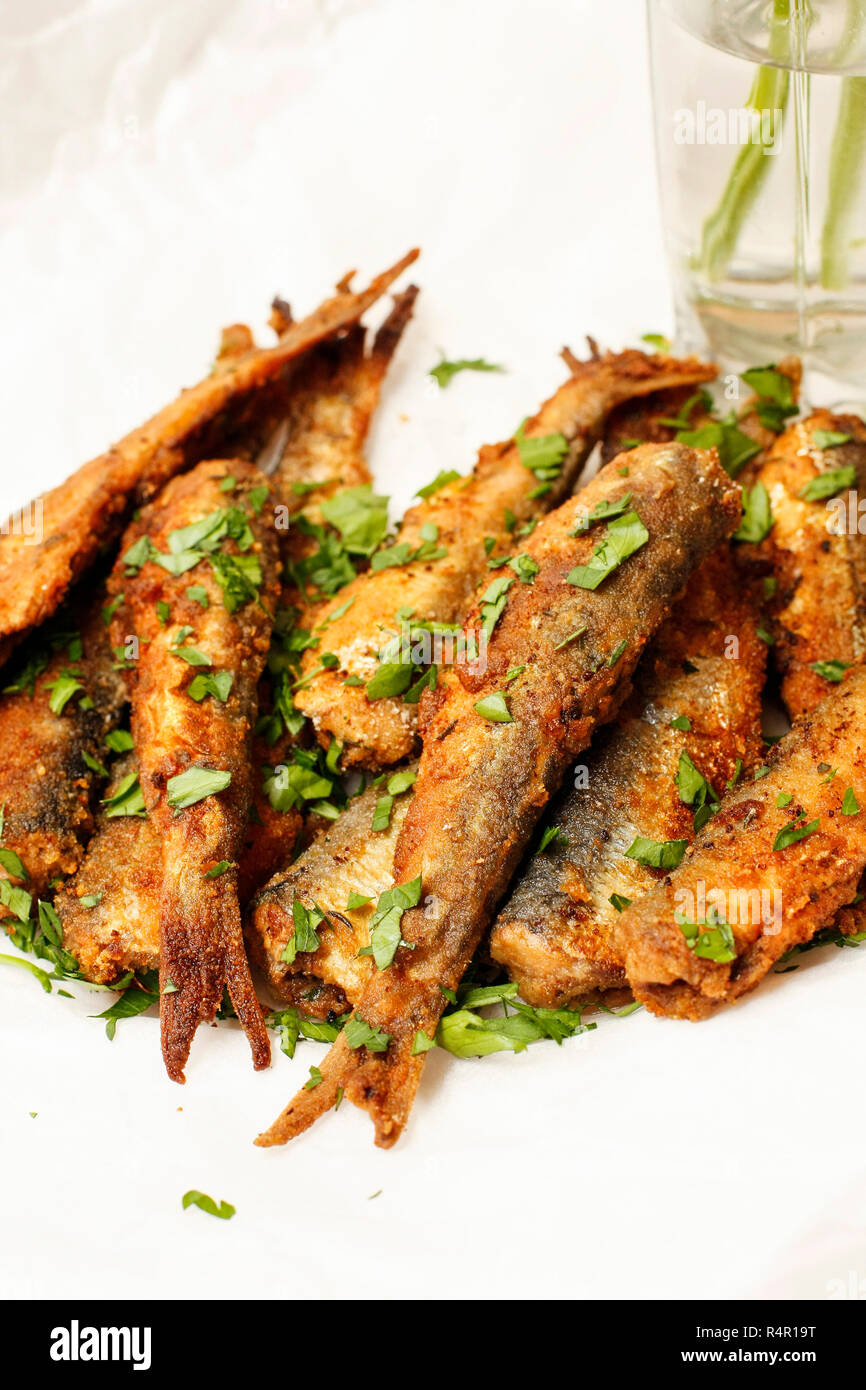Easy fried pickled herring fish on white platter Stock Photo - Alamy