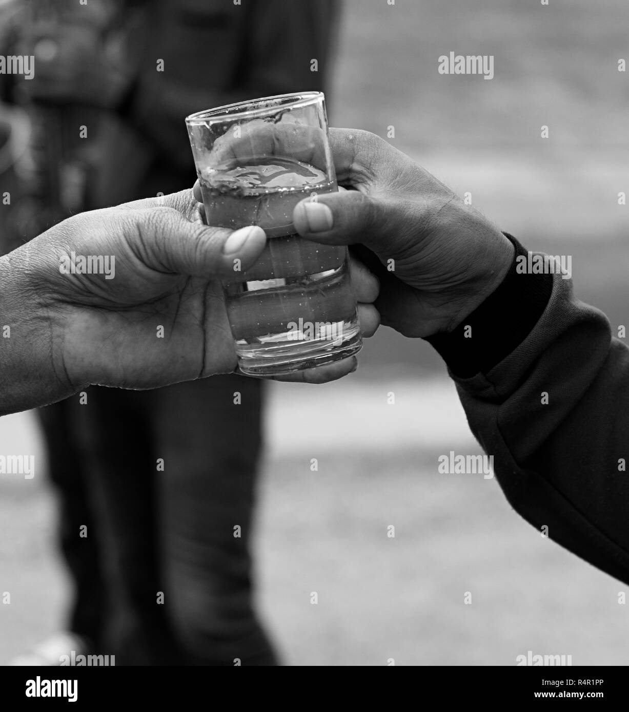 hand glass water giving black white Stock Photo - Alamy