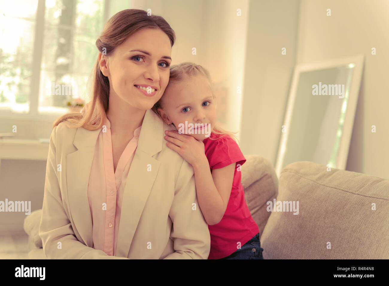 Positive nice mother and daughter looking at you Stock Photo - Alamy