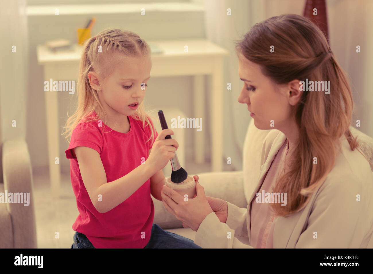 Pleasant cute girl holding hi-res stock photography and images - Alamy