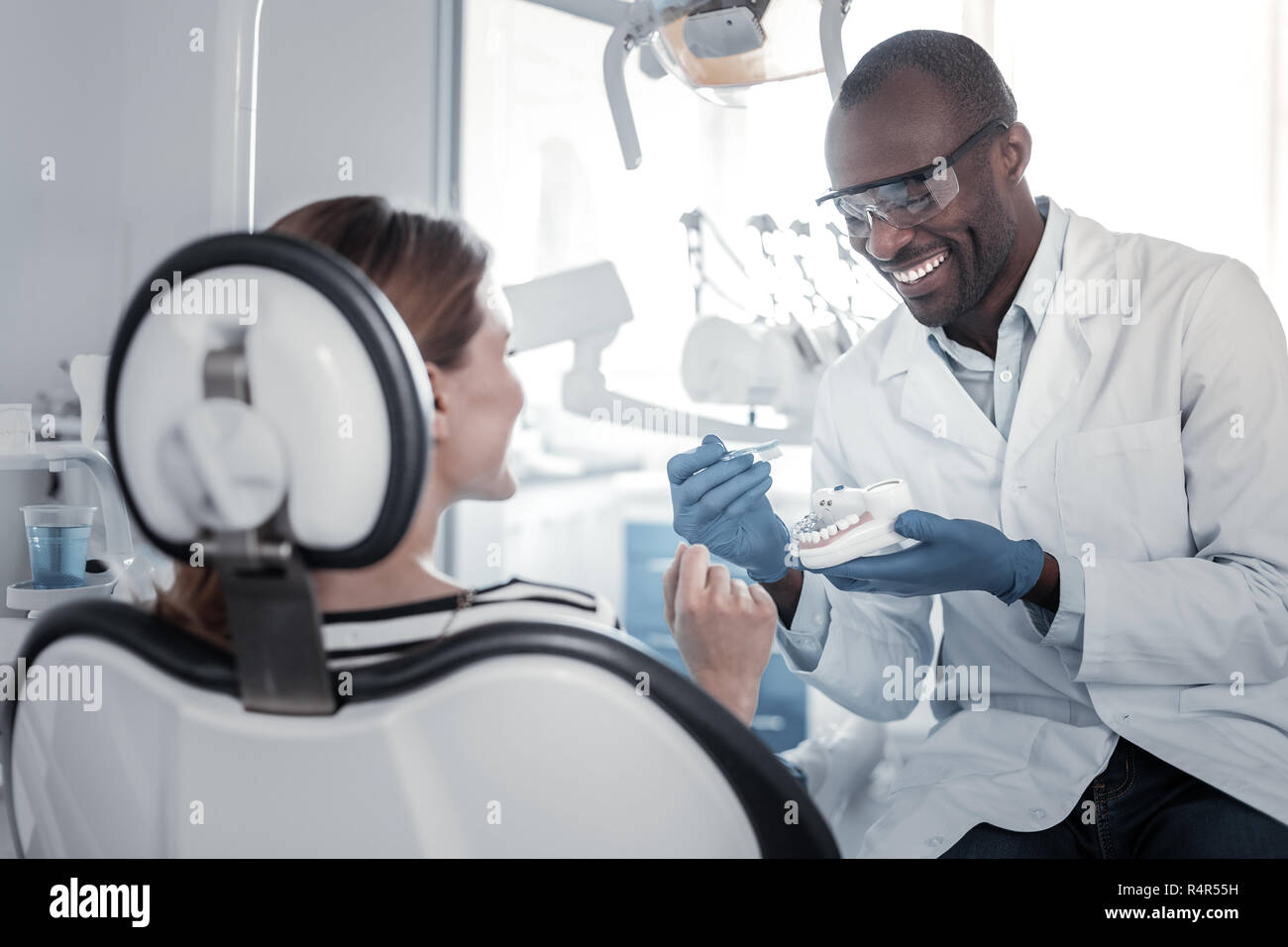 Positive delighted people looking at artificial jaw Stock Photo - Alamy