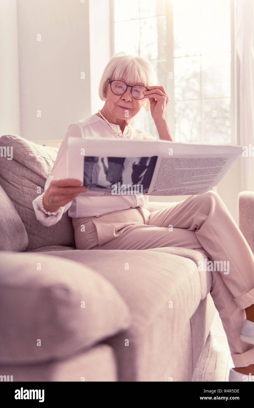 Grey haired lady reading a newspaper hi-res stock photography and ...