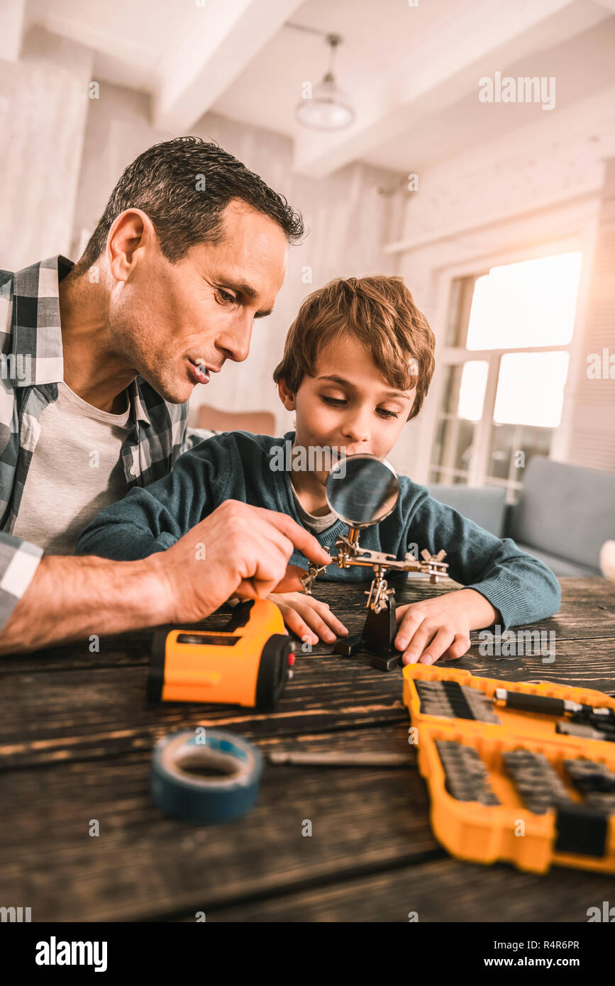 Responsible adult engineer bringing his son into the world of ...