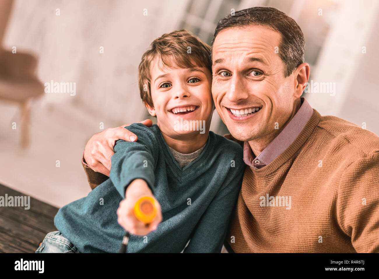 Happy smiling parent and child gladly posing for the picture while ...