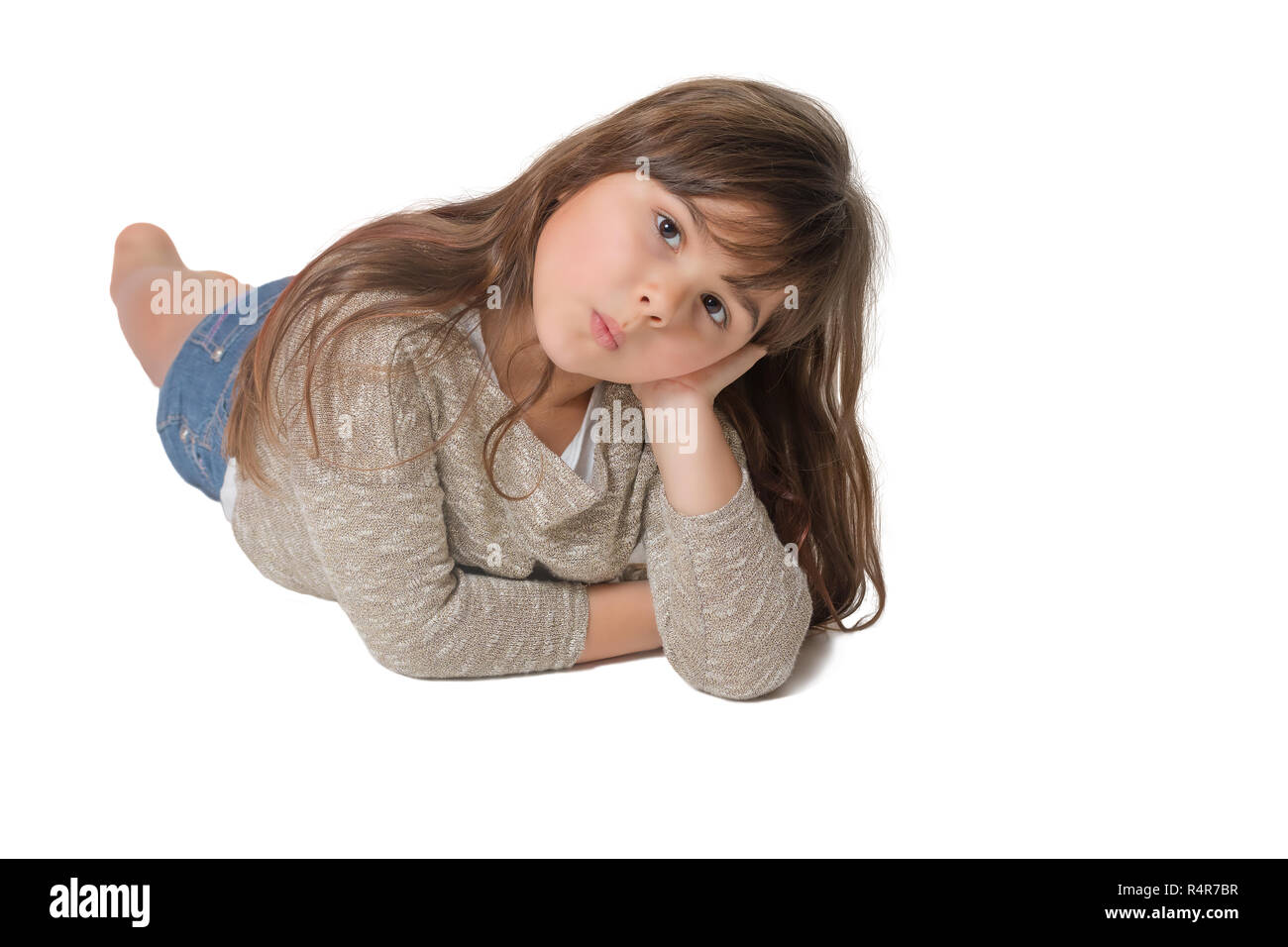 Little girl with spitting lips is lying on the gray background Stock ...