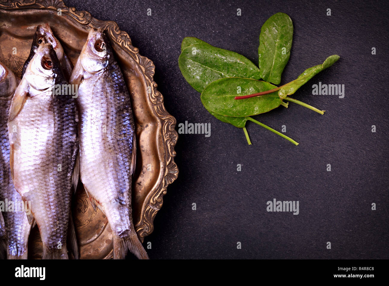 dried tar ram in a copper plate on a black surface Stock Photo - Alamy