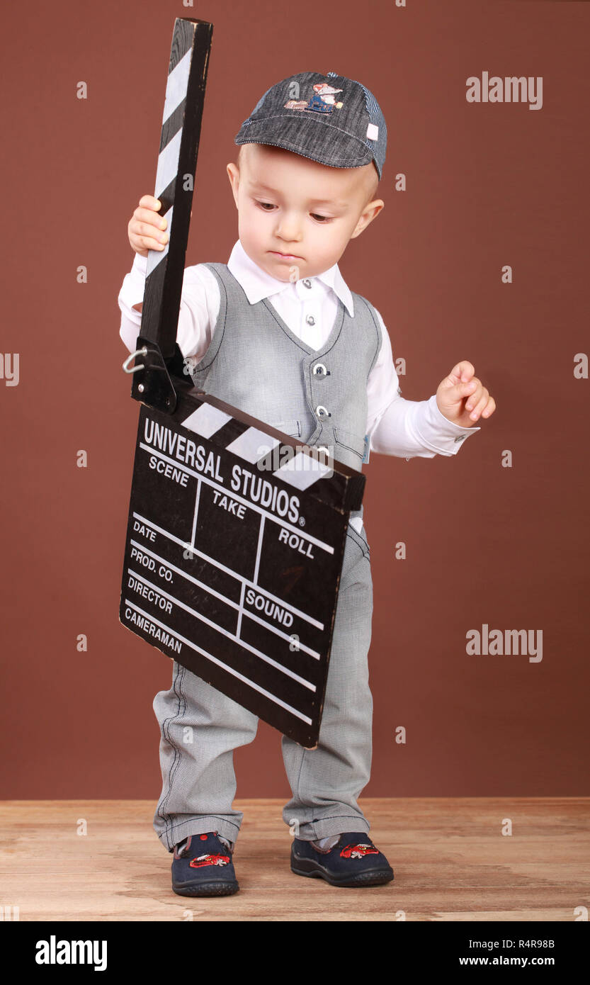 Cute little boy with cinema clapper Stock Photo - Alamy