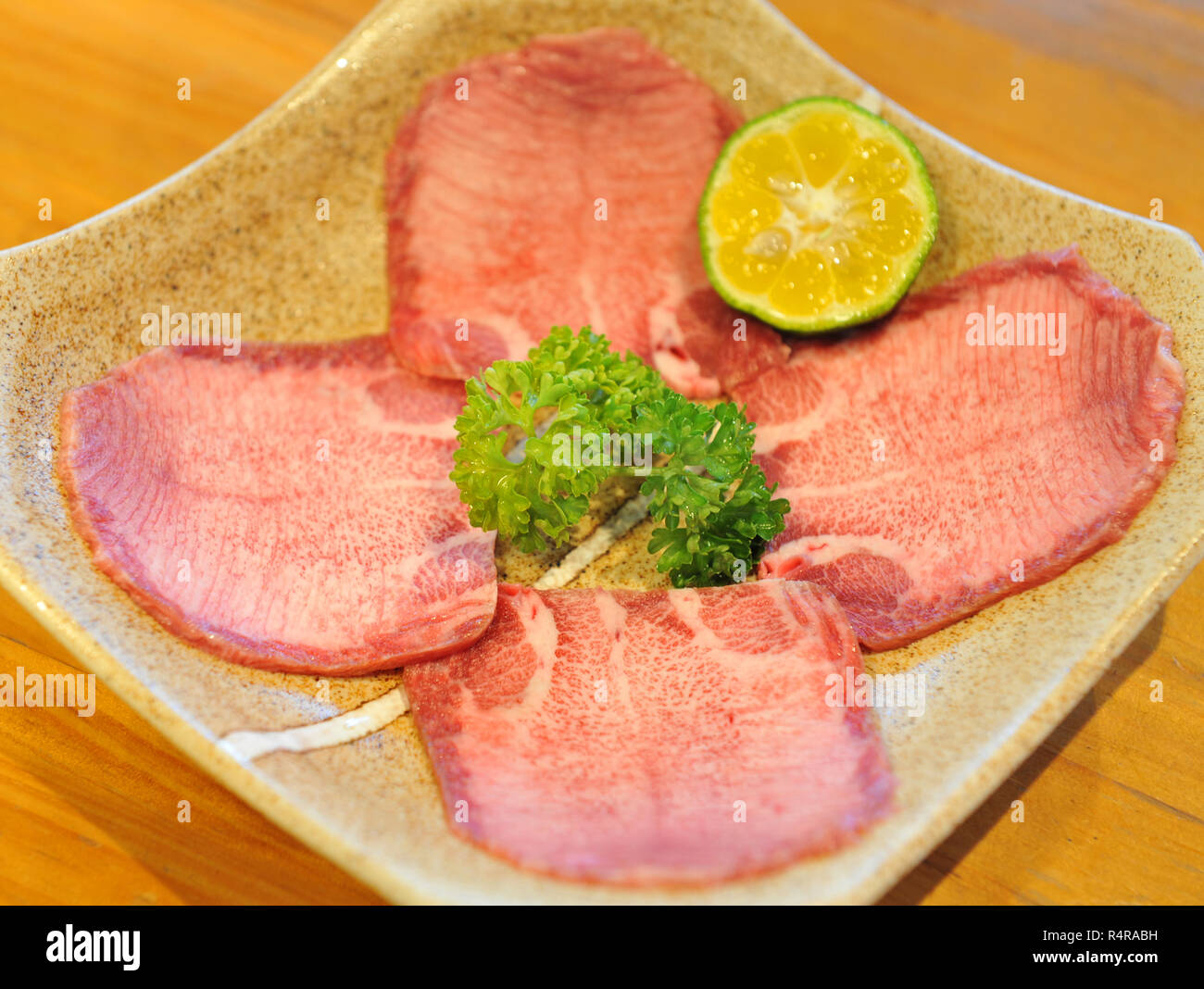 Delicious fresh sliced beef tongue with lime Stock Photo - Alamy