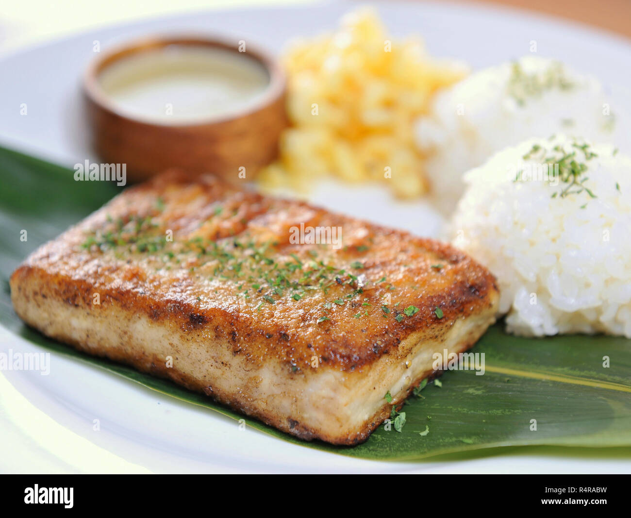 Platter of rice with fried fish fillet Stock Photo - Alamy