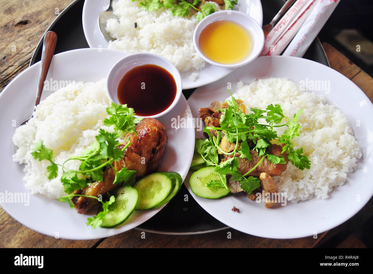 Vietnamese broken rice or com tam with fried chicken legs, pork and ...