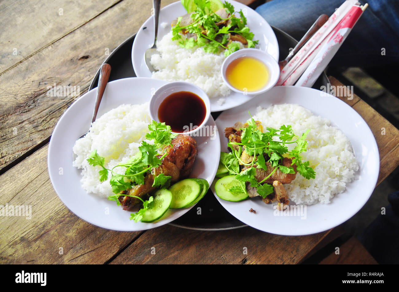 Vietnamese broken rice or com tam with fried chicken legs, pork and ...