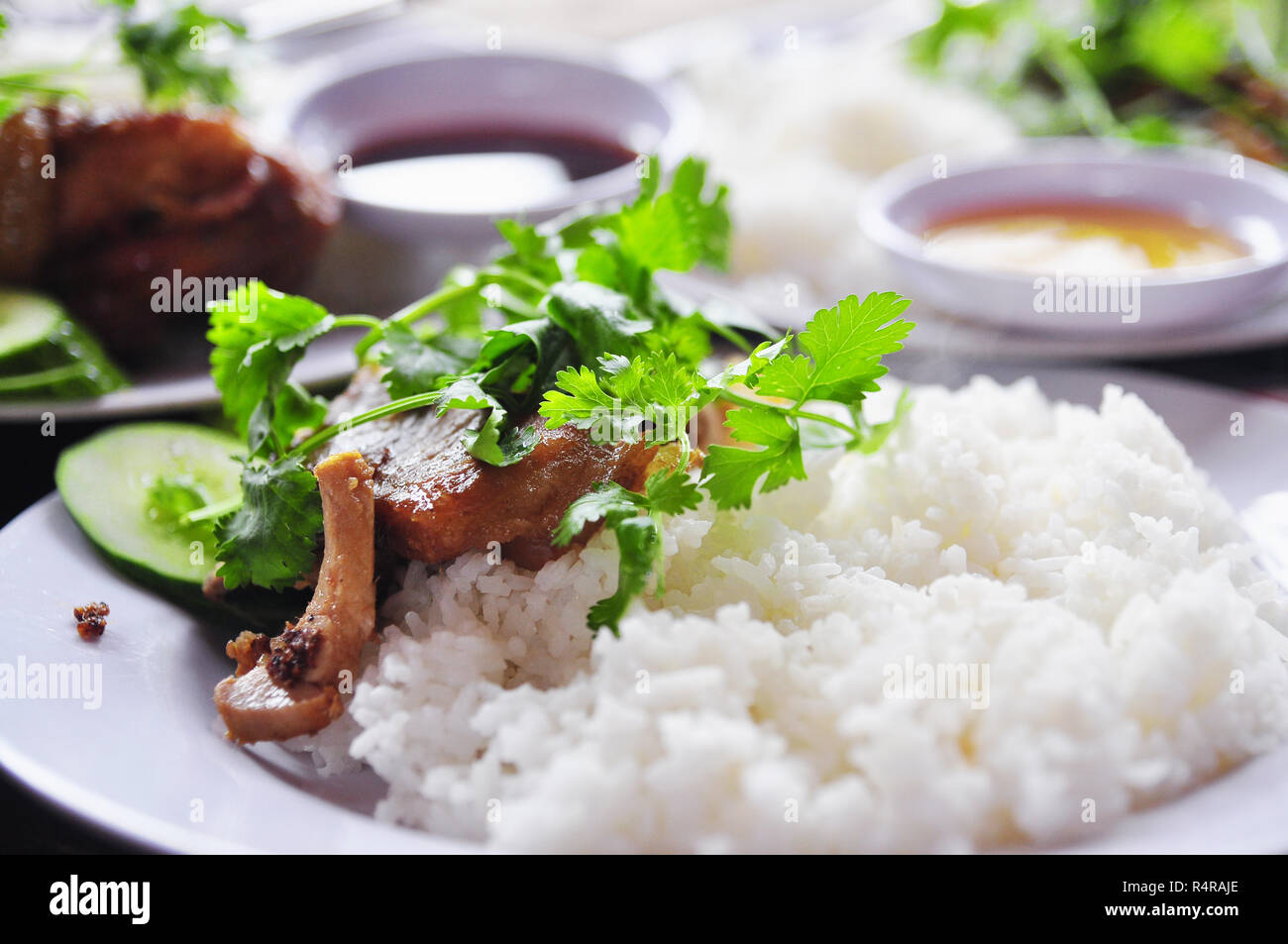 Vietnamese broken rice or com tam with fried chicken legs, pork and ...